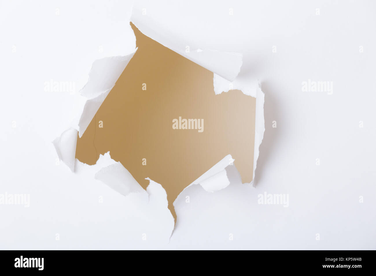 Hole in the paper with torn sides Stock Photo - Alamy