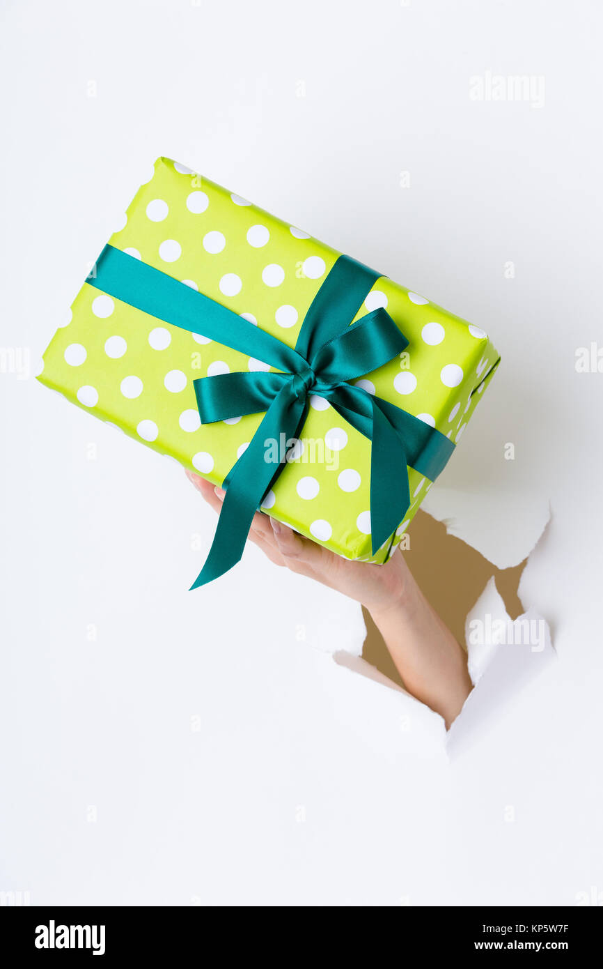 Hand breaking through paper holding hi-res stock photography and images ...