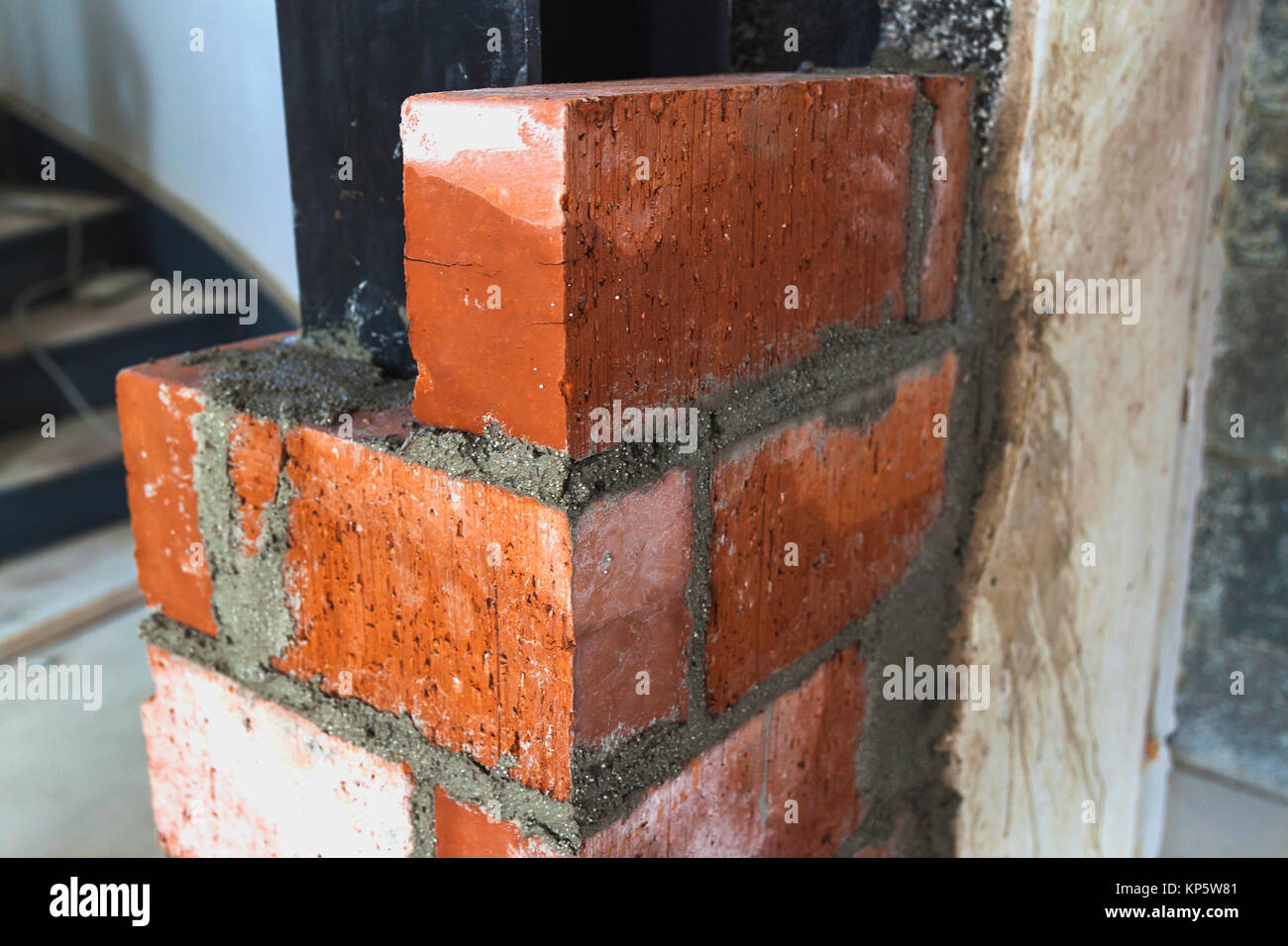 Close up of bricklaying industrial installing bricks on construction ...