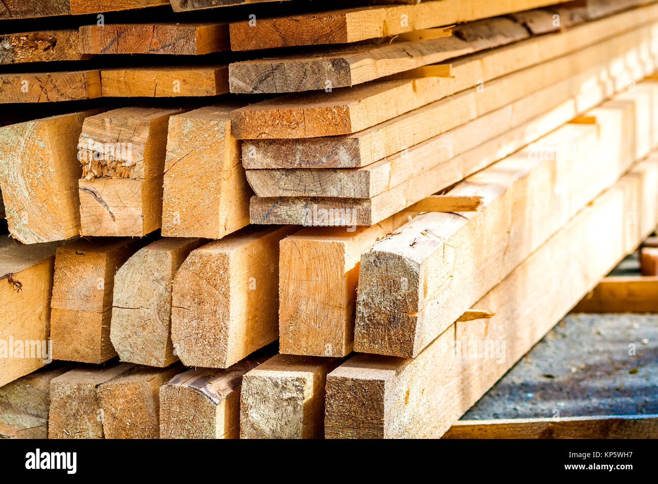 Stack of building lumber at construction site with narrow depth of ...