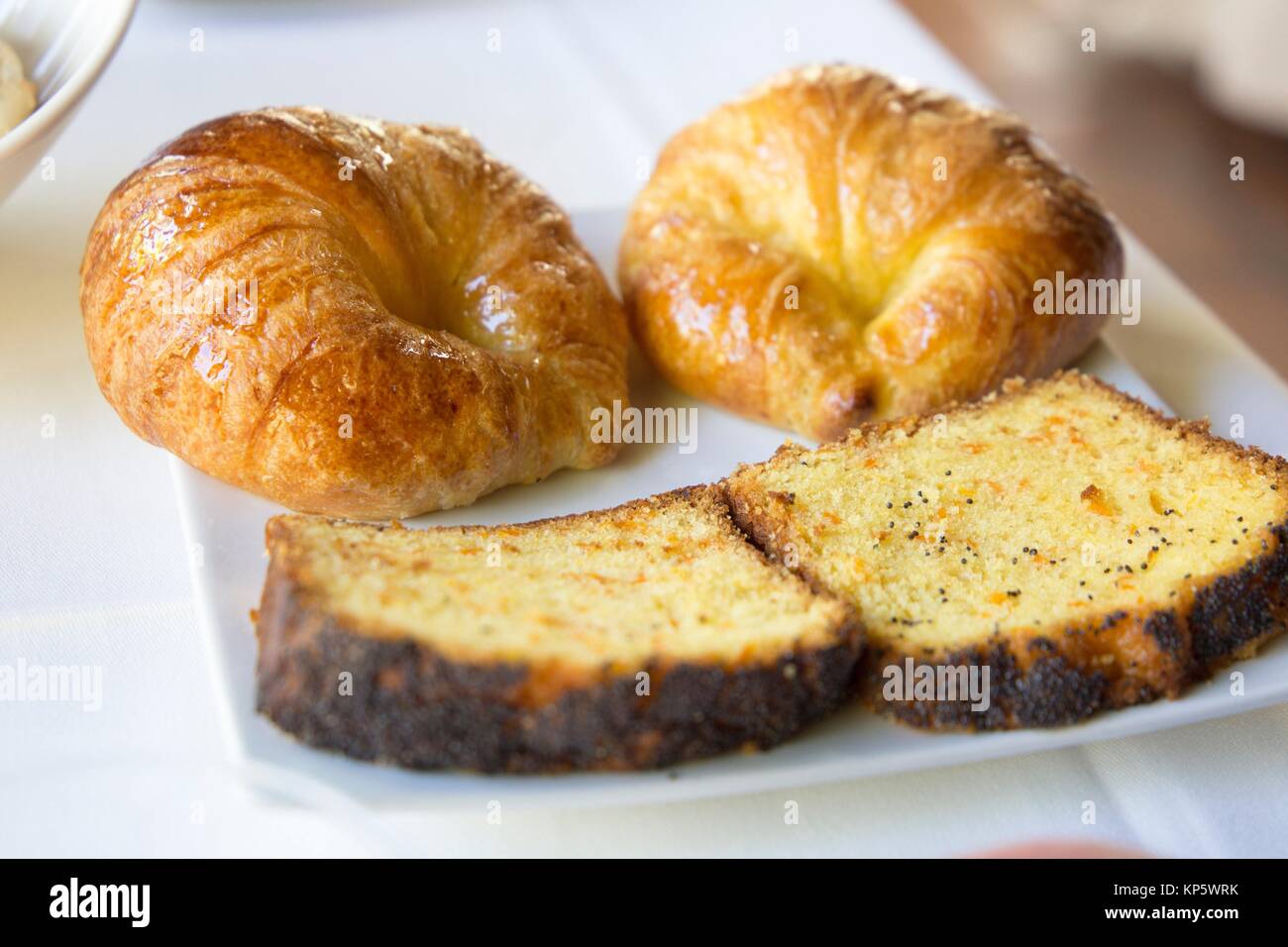 Croissant and sponge cake for two on plate Stock Photo - Alamy