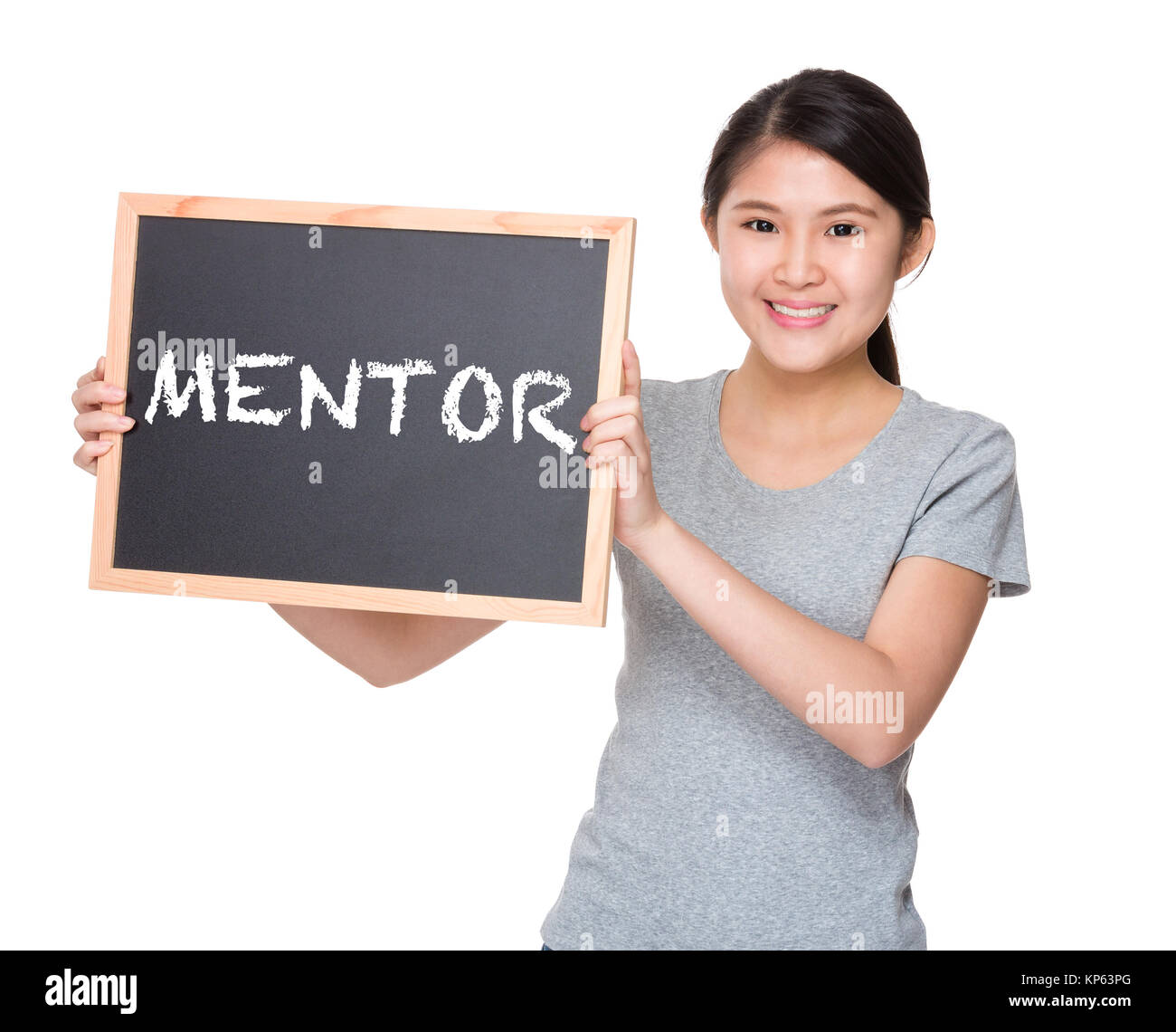 Young student hold with black board showing a word mentor Stock Photo ...