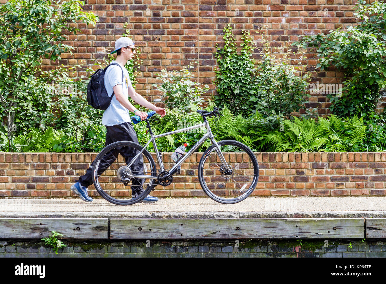 Pushing a bike hi-res stock photography and images - Alamy