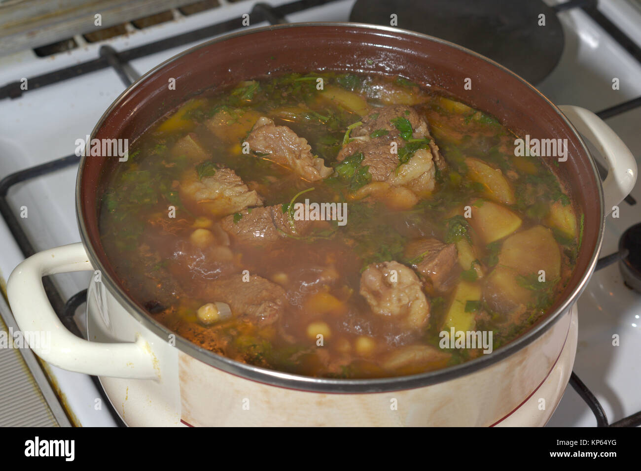 cooking of Oriental lamb soup with dried fruits called Bozbash Stock ...