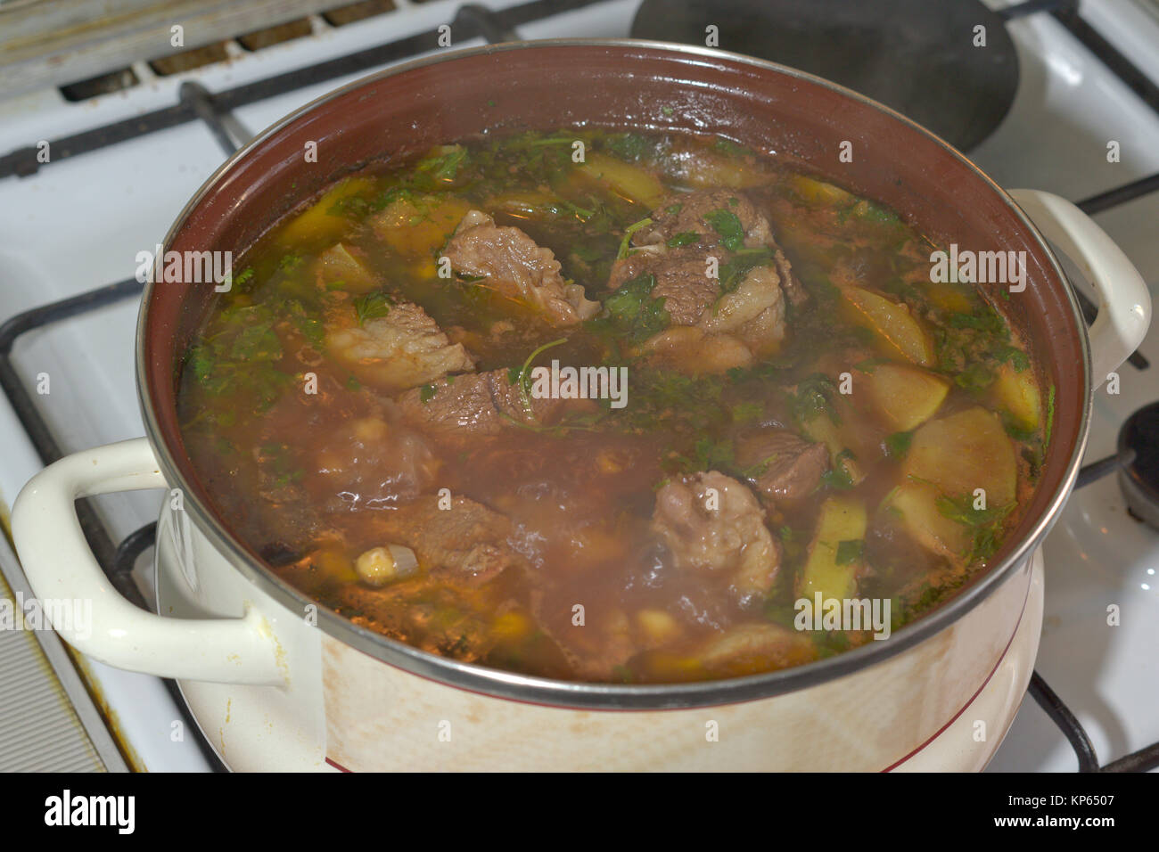 delicious meat soup, boiling on the stove. The famous Caucasian dishes ...