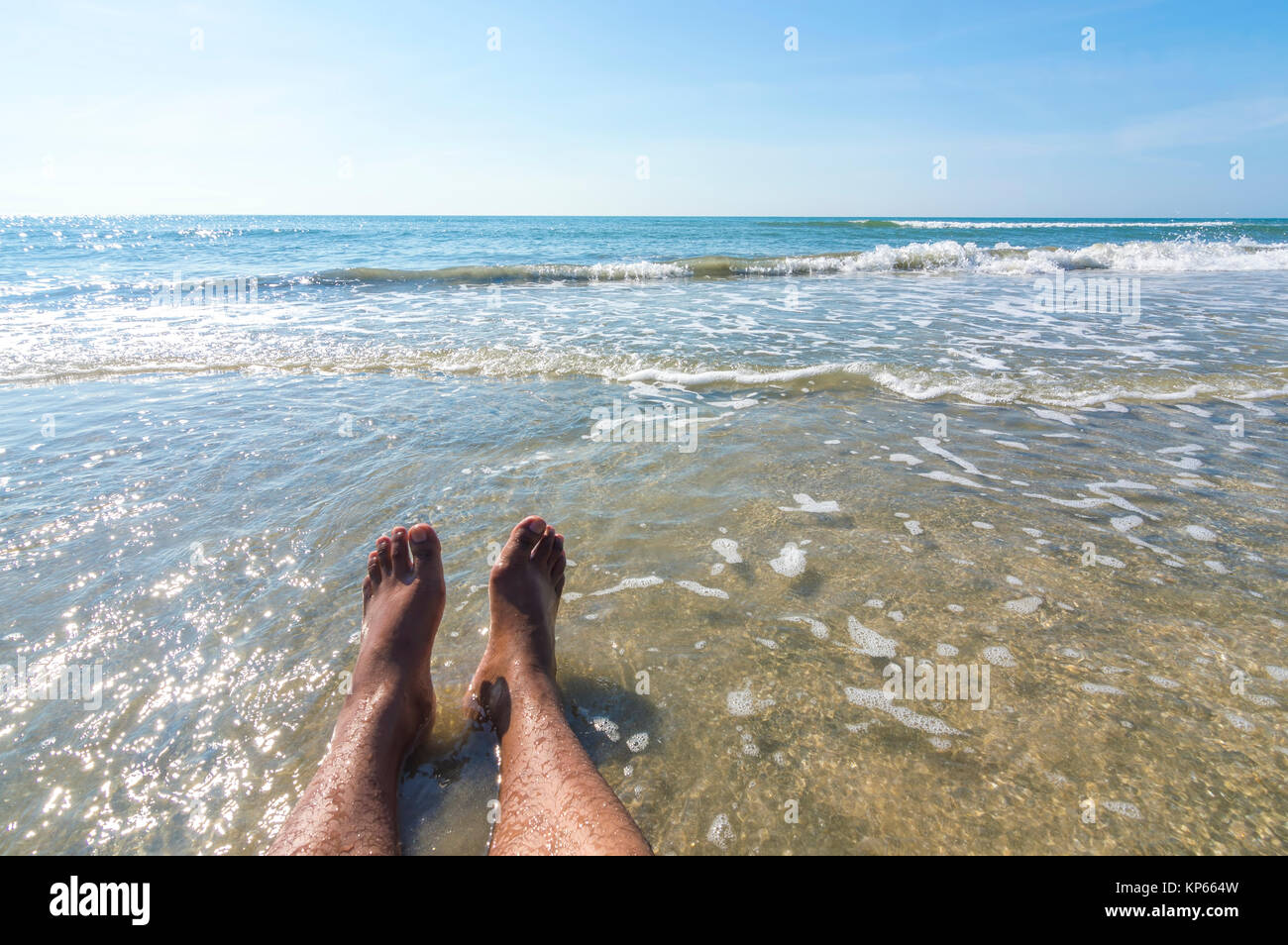 Man legs on the beach with direct sunlight Stock Photo - Alamy