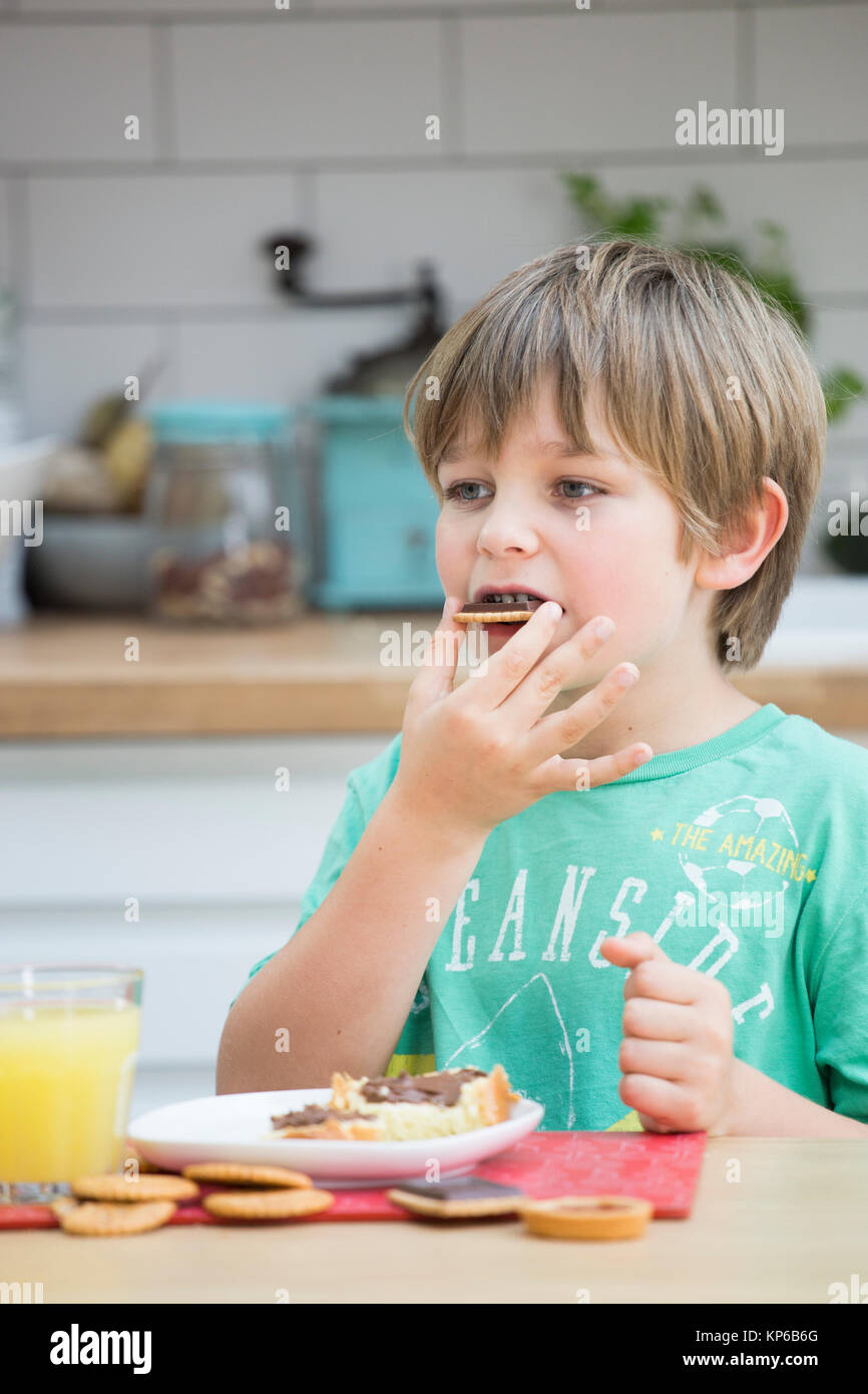 Child eating chocolate biscuit hi-res stock photography and images - Alamy