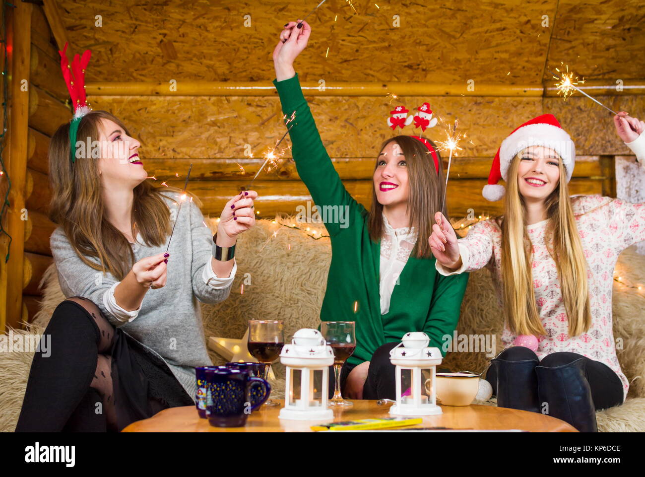 Friends having fun with fire sparkles on home Christmas party Stock ...