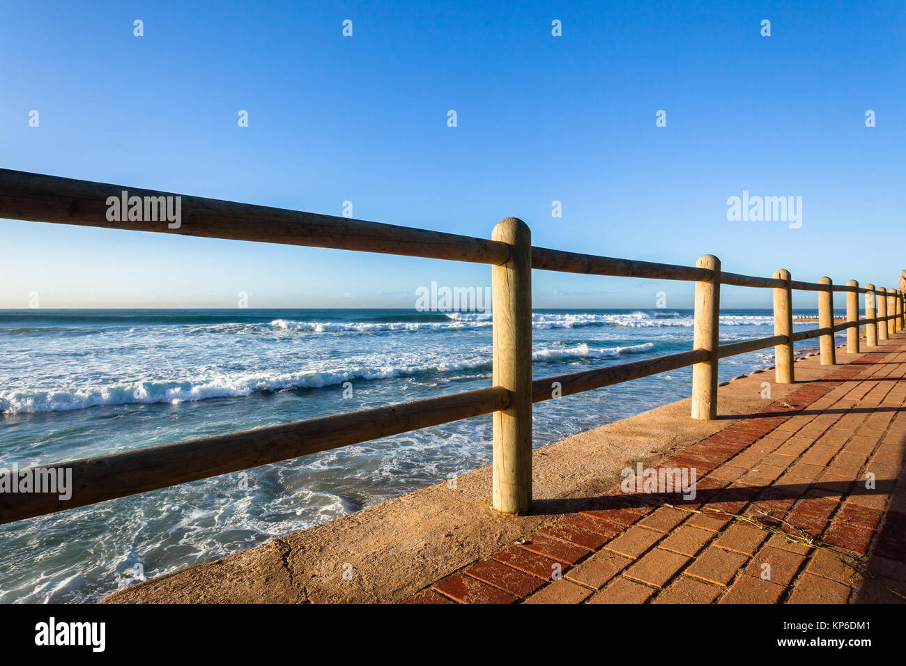 Beach walking path pole fence overlooking ocean waves coastline Stock ...