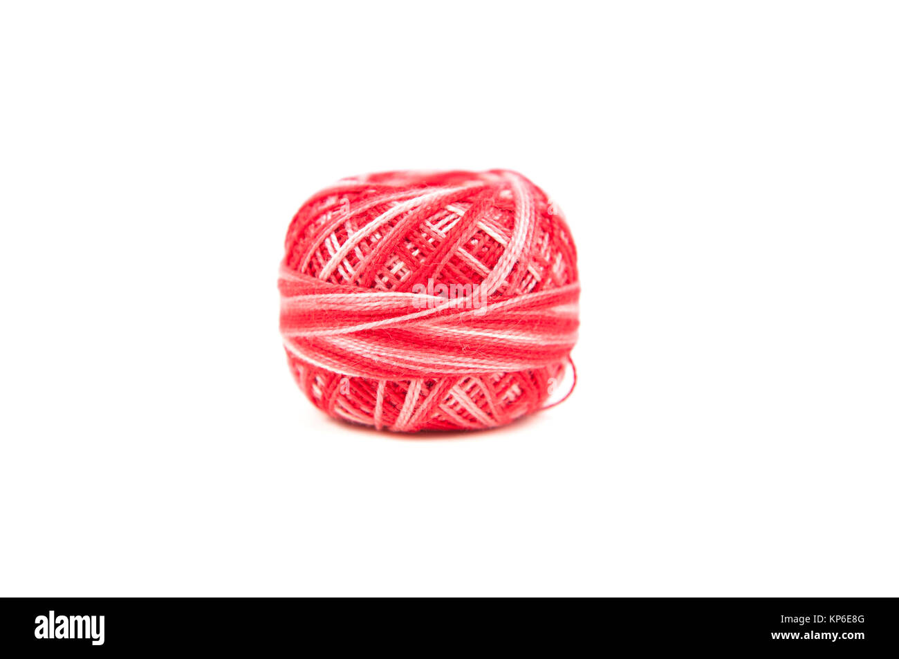 Red sewing thread on white background Stock Photo - Alamy