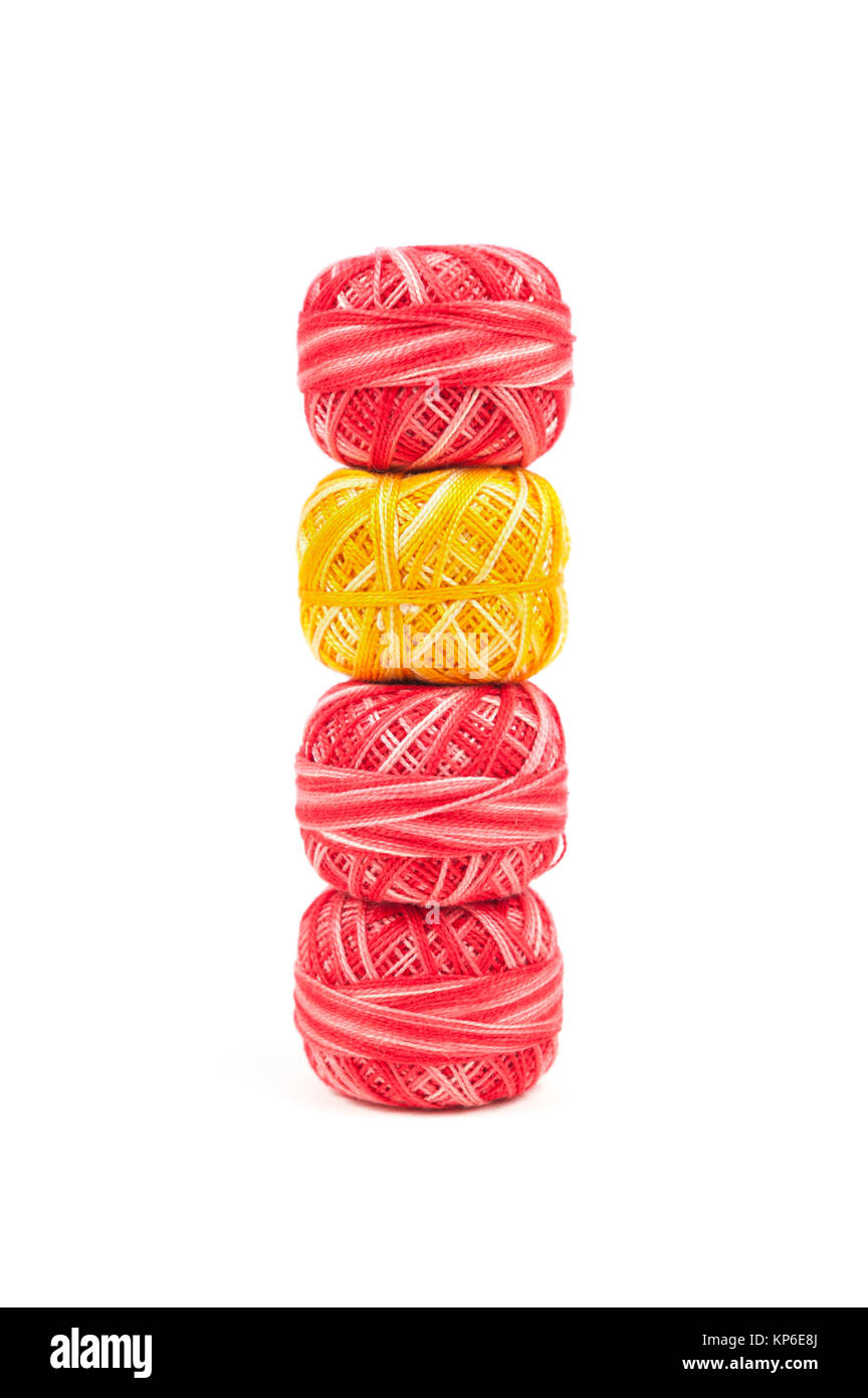 Four sewing threads on white background. Red and yellow thread Stock ...
