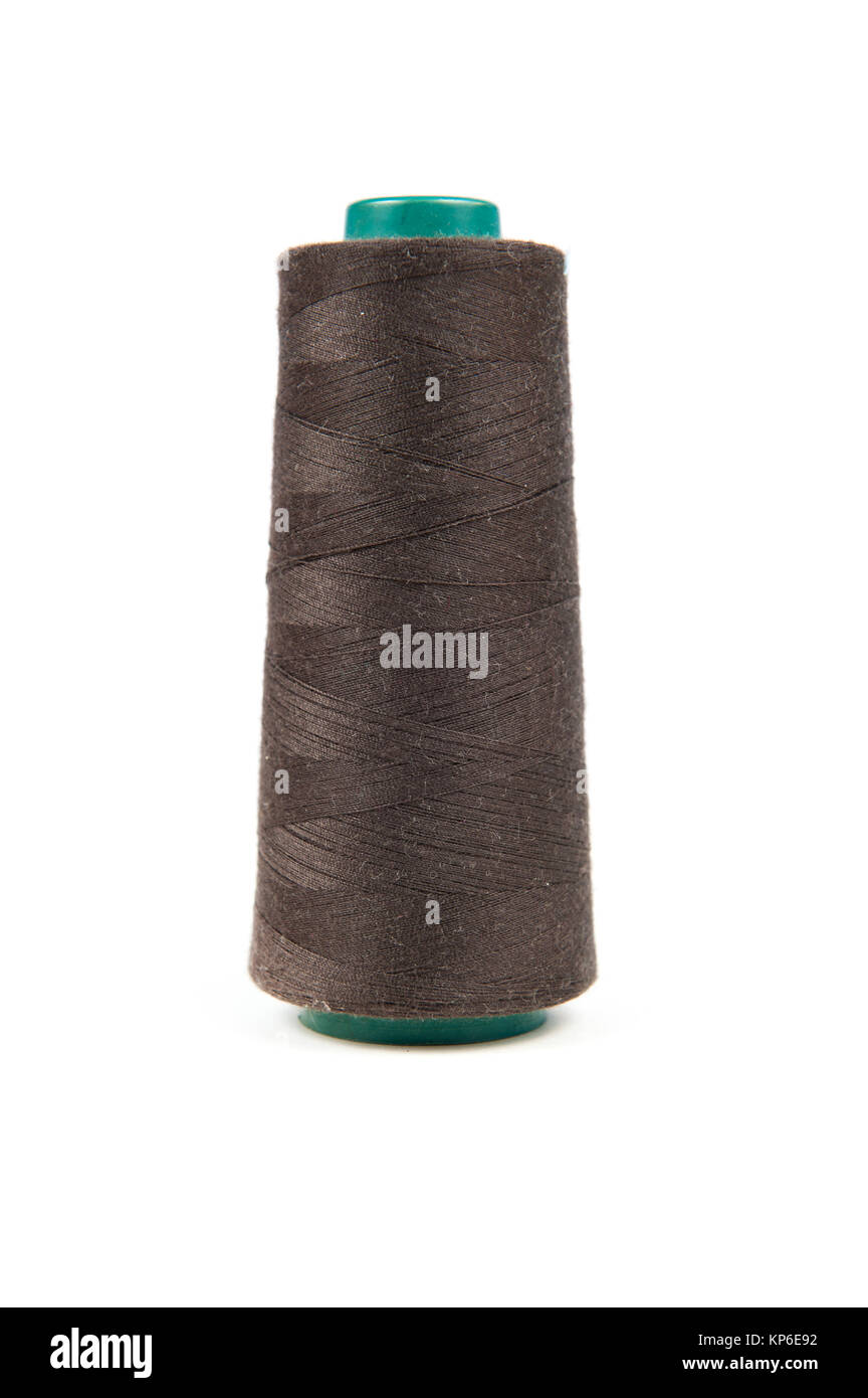 Big dark brown spool of thread on white background Stock Photo - Alamy