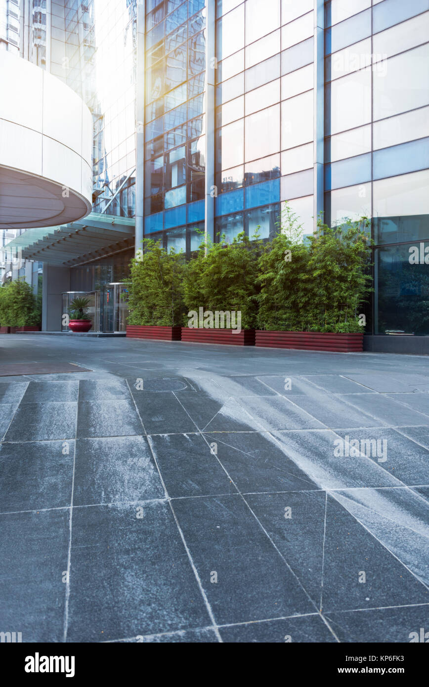 empty brick floor with modern building in background Stock Photo - Alamy