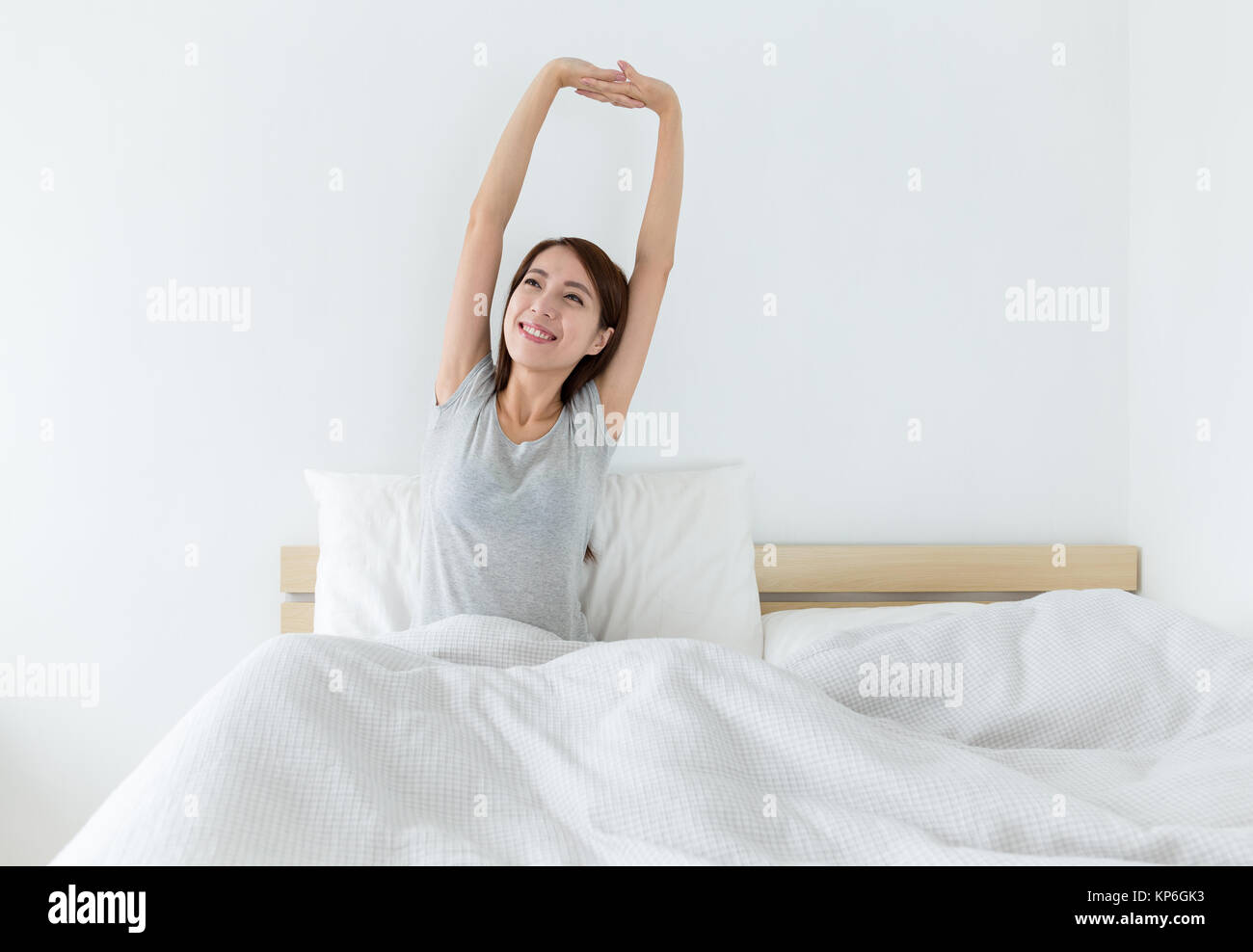 Woman just wake up with hand stretching Stock Photo - Alamy