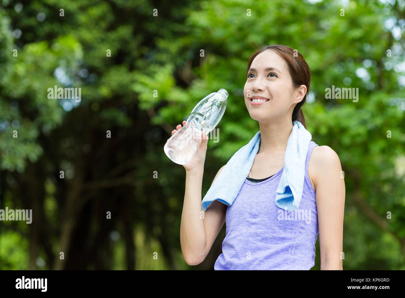 Woman drinking water after running Stock Photo - Alamy