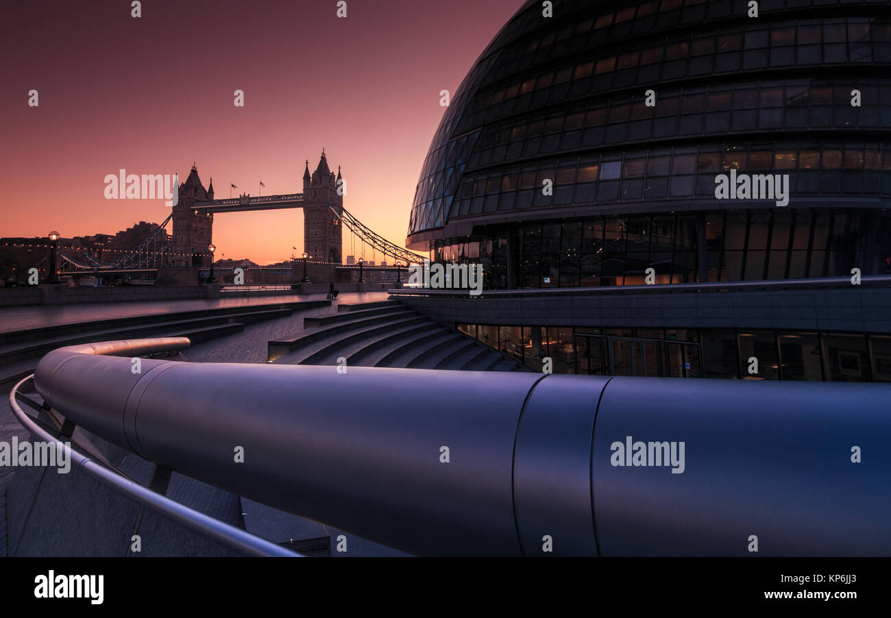 A glowing sunrise over Tower Bridge and City Hall in London Stock Photo ...