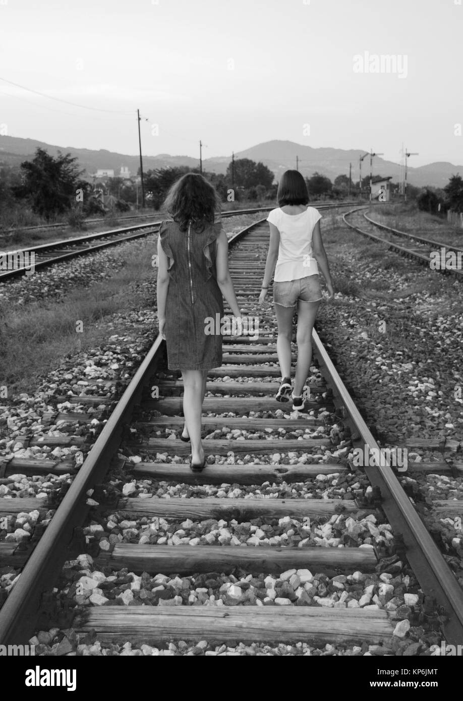 two girls on the railroad Stock Photo - Alamy