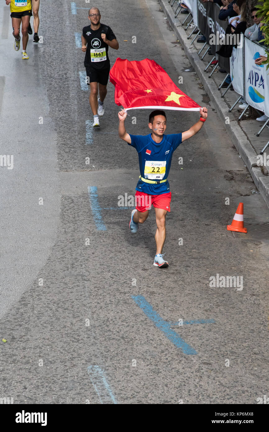 He Wei Rong is going to the finish line waving the flag of his country ...