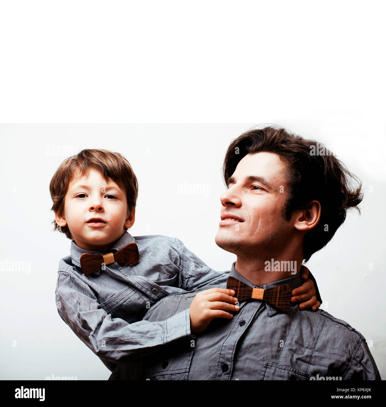 father with son in bowties on white background, casual look normal ...