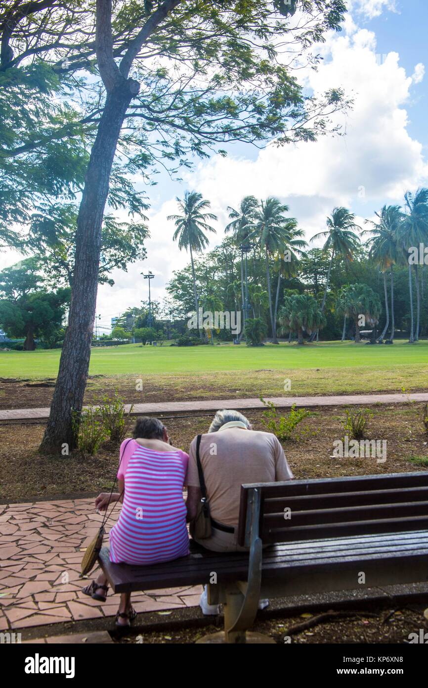 Very Old couple sitting on a bench hunch down looking at the ground in ...