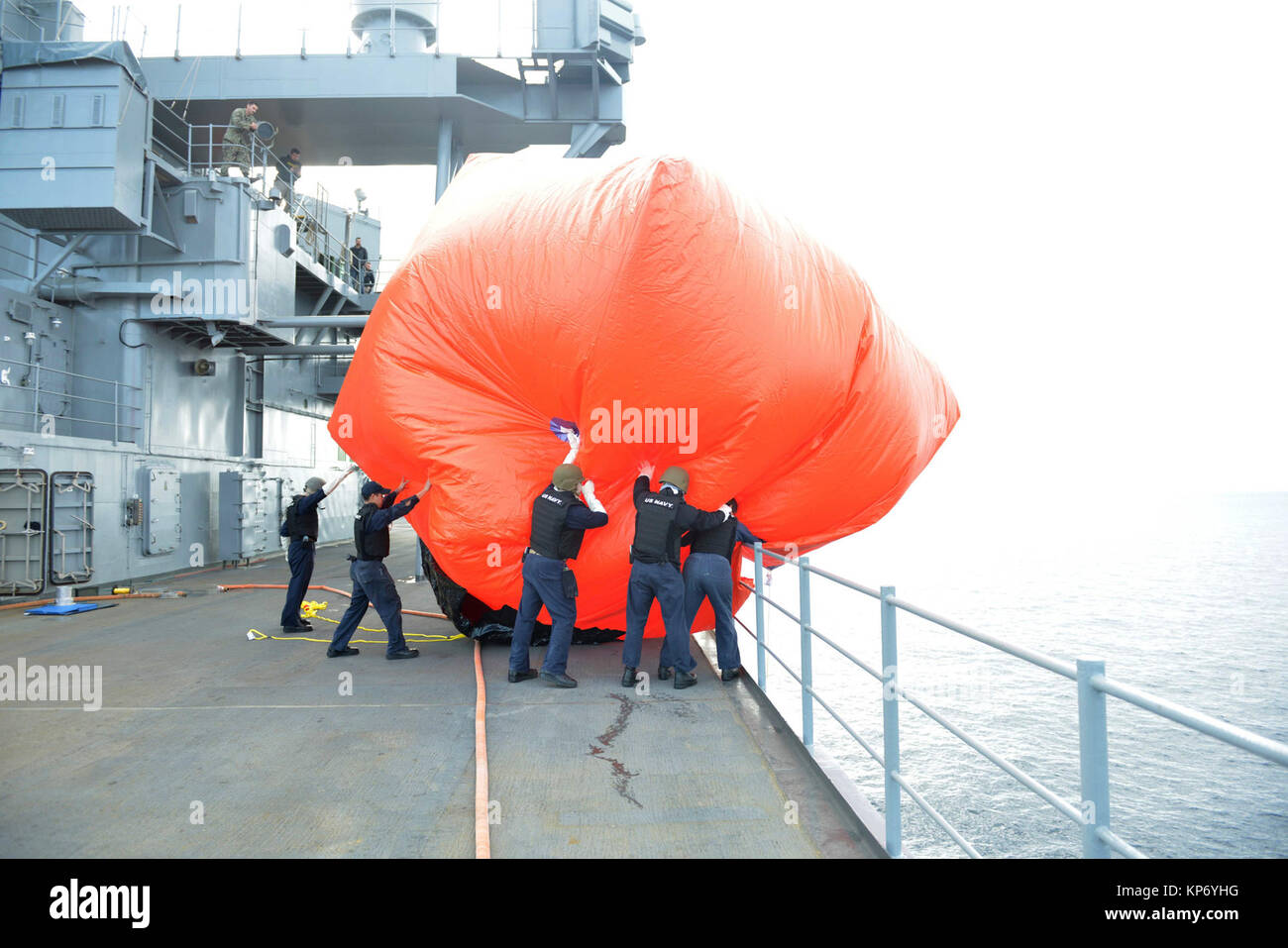 Sailors deploy a “killer tomato” inflatable target from the main deck ...