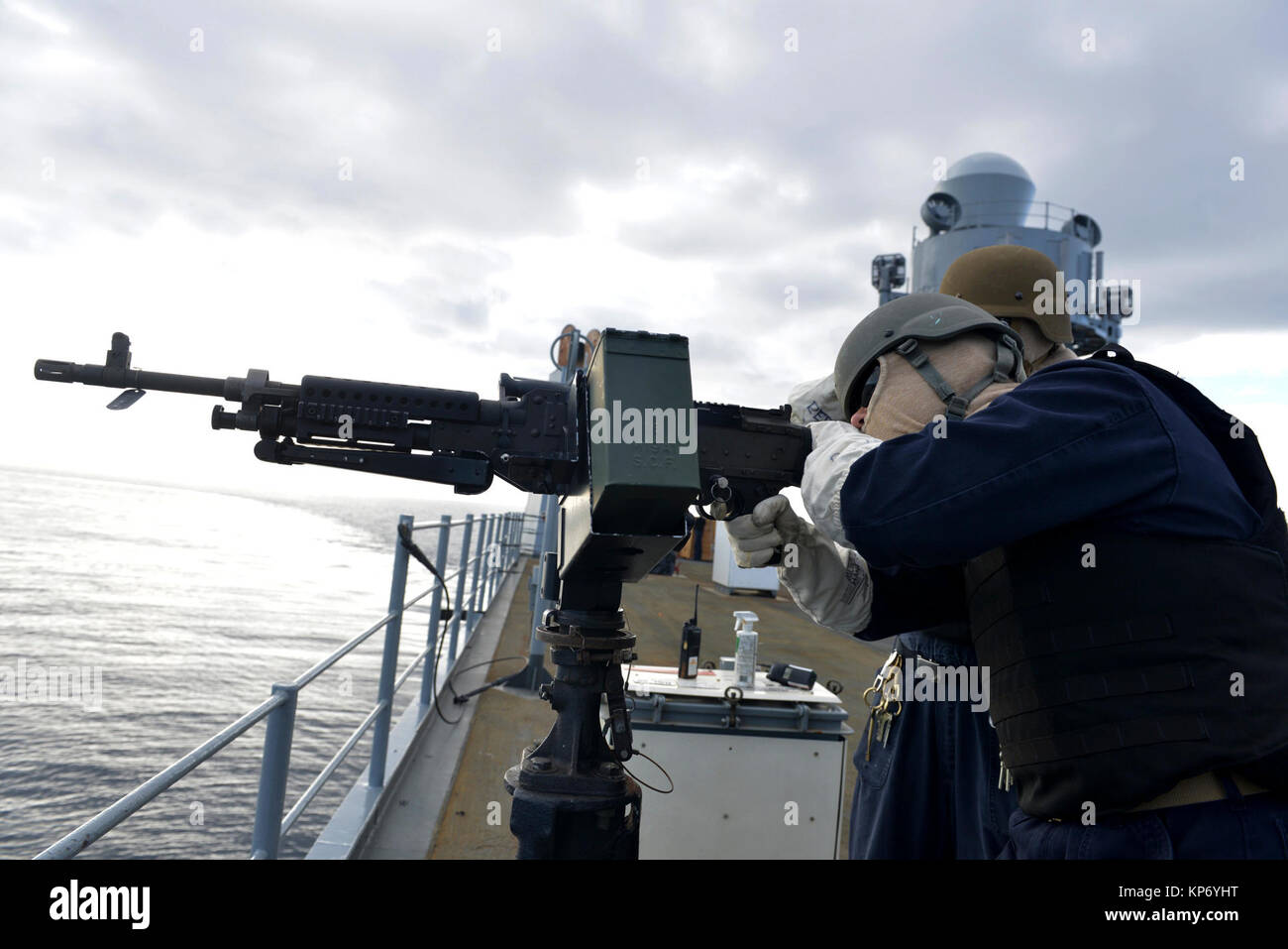 Chief Master-at-Arms Mark Miller fires an M240B machine gun during a ...