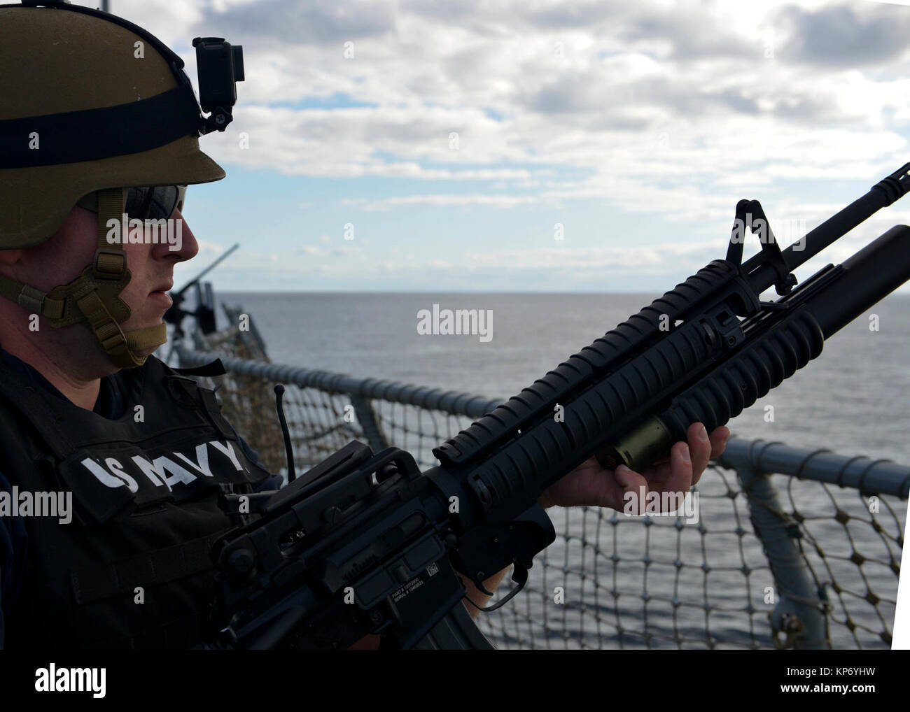 Gunner’s Mate 1st Class Adrian Rodziewicz loads an M203 grenade ...