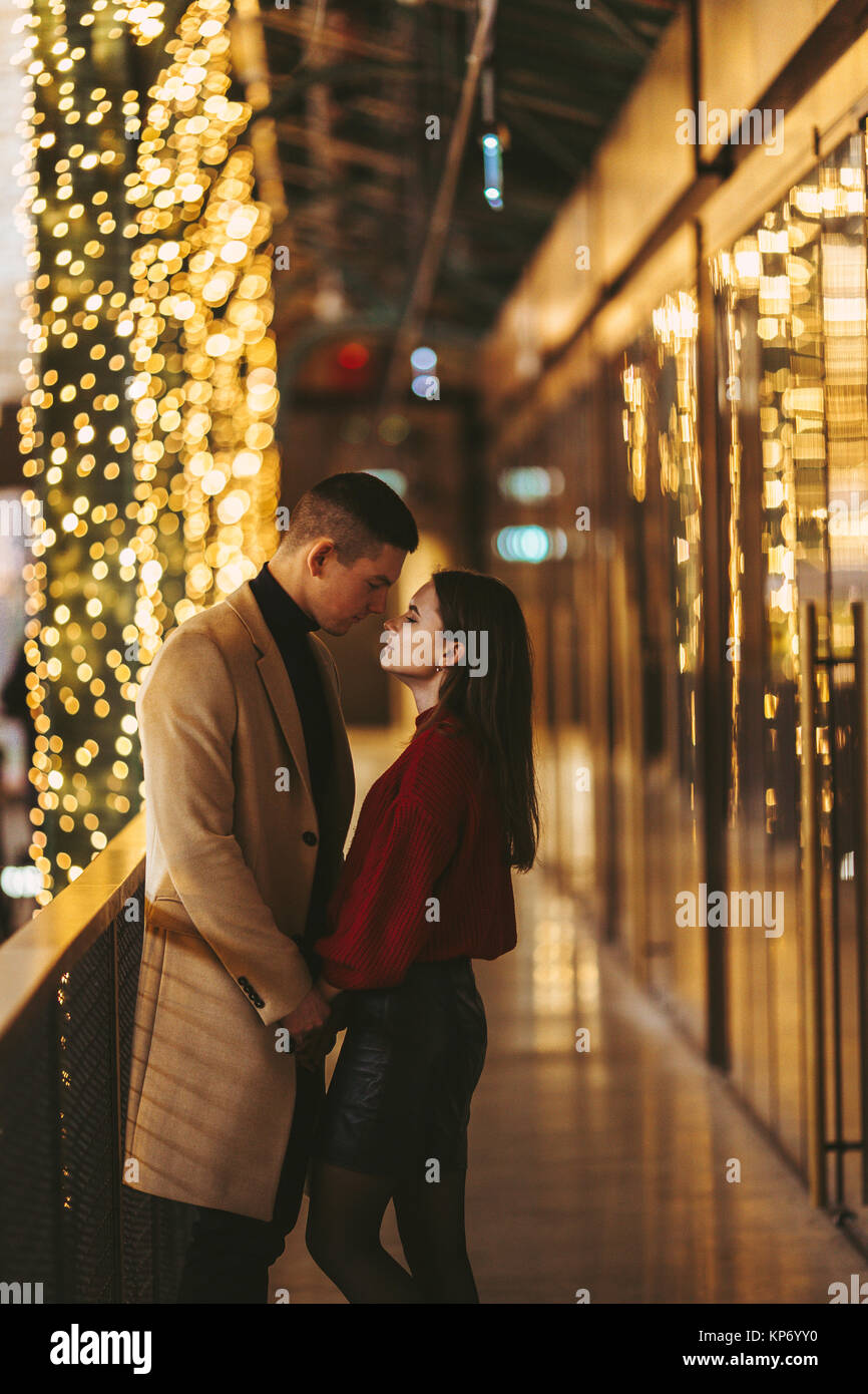 Lovely couple stand at the shop centre and hug each other Stock Photo ...