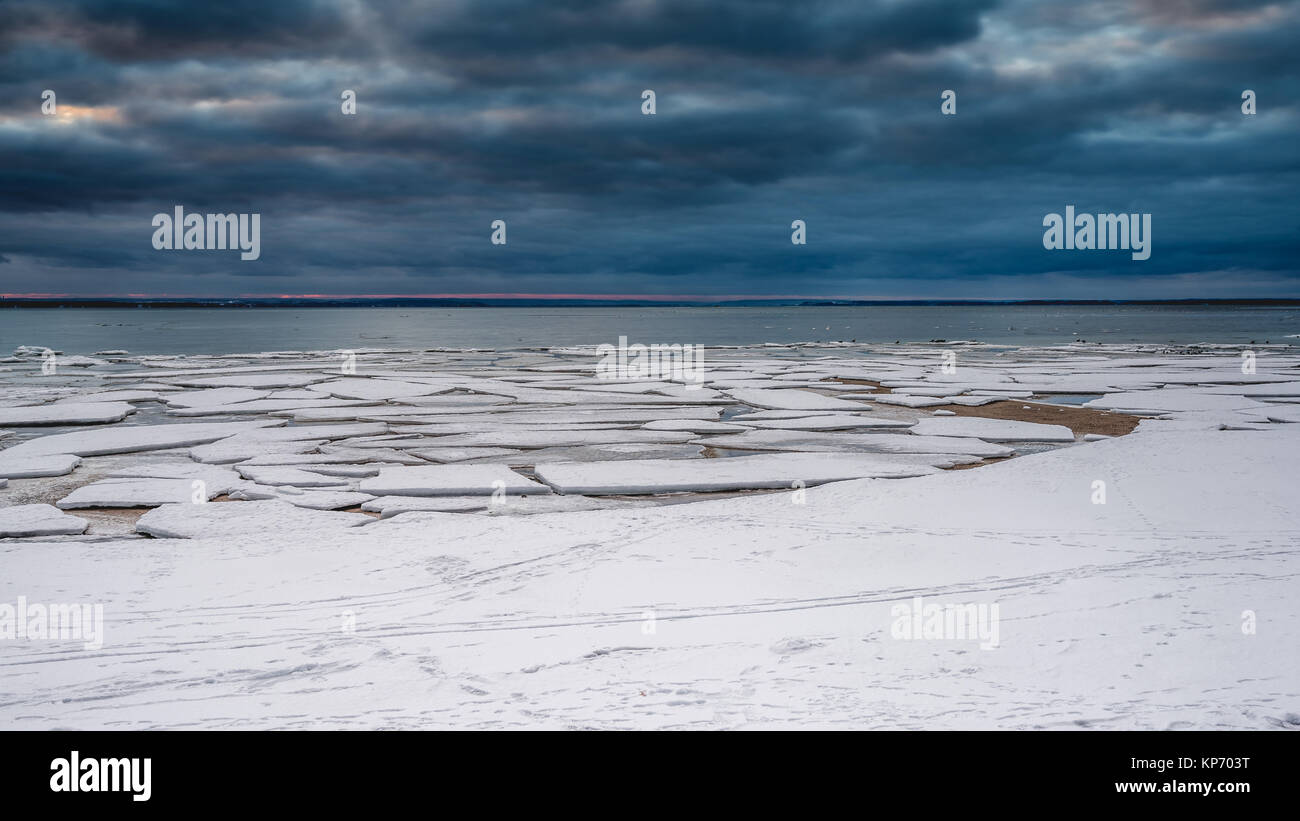 Frozen winter seascape with ice and cloudy sky in the evening. Baltic ...