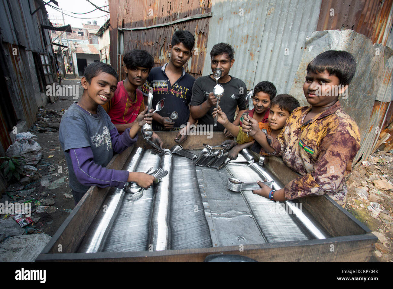 Labors are loading steel spoon at a local van Stock Photo - Alamy
