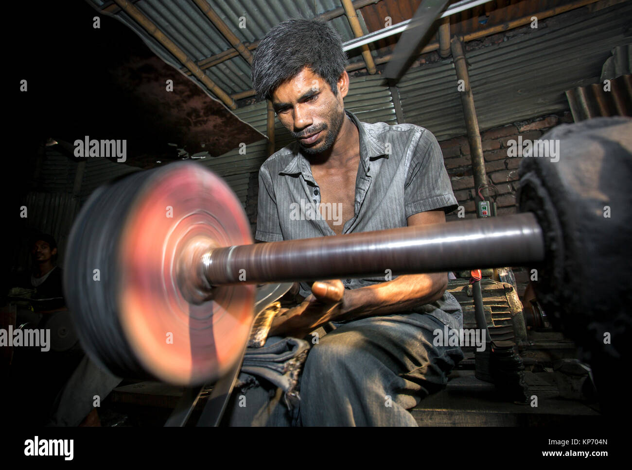 Spoon-Making Factory Workers at a steel recycling and steel spoon ...