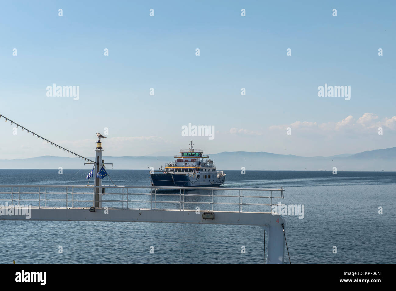 Ferry boat in the sea with passengers on board, back view Stock Photo ...