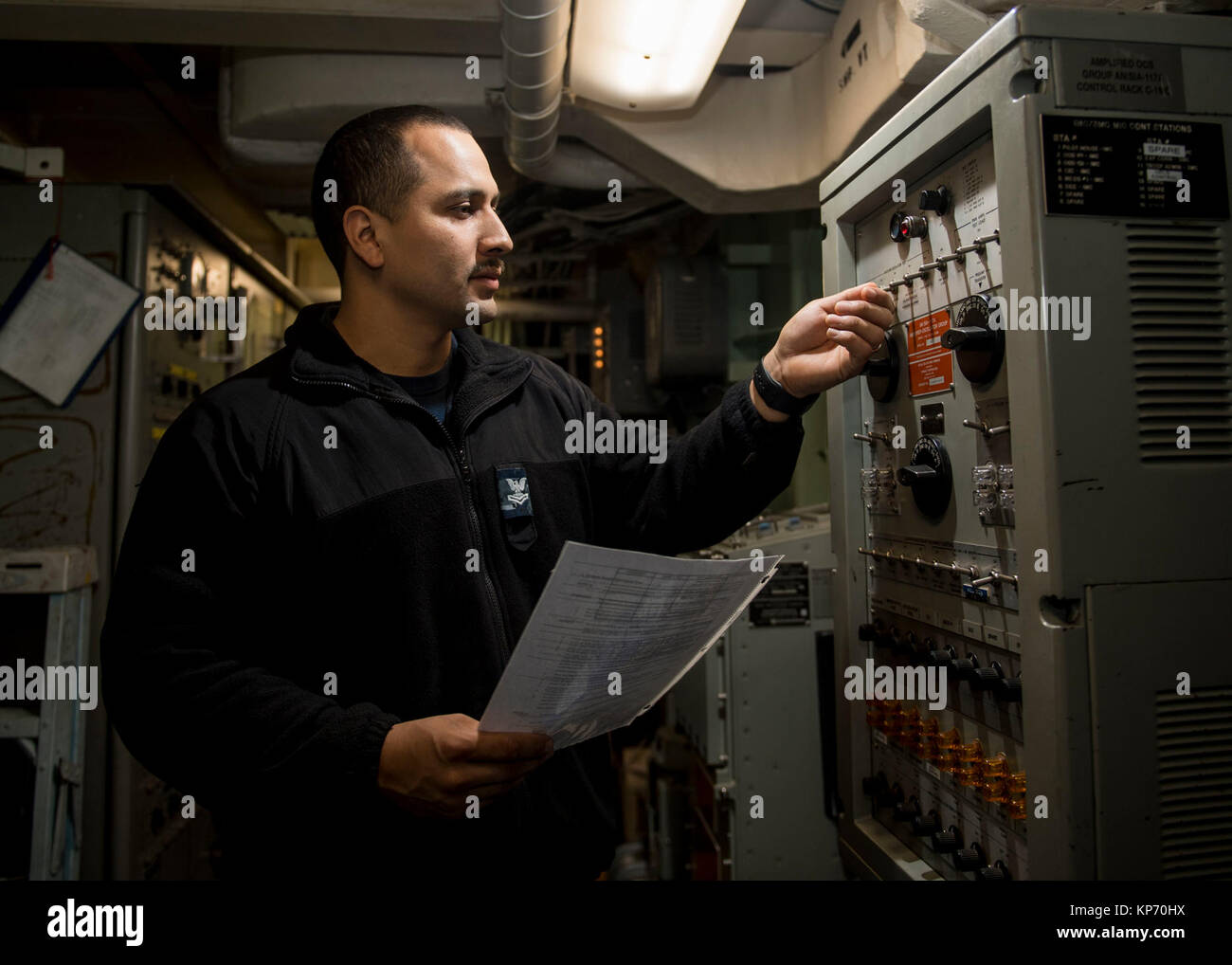 Interior Communications Electrician 2nd Class Damien Contreras performs ...