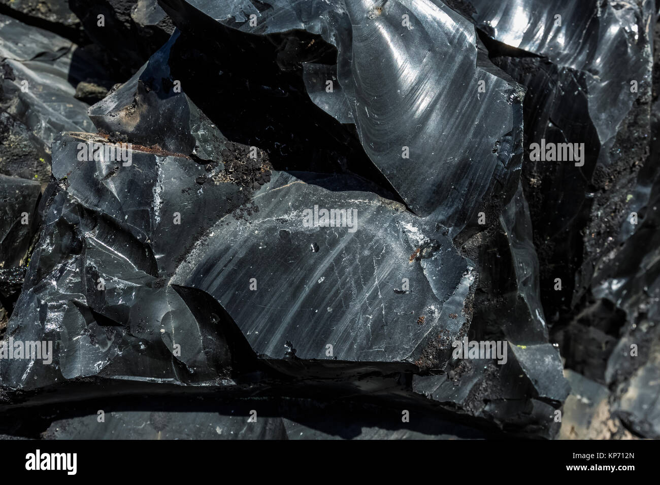 Close-up of obsidian, with its combination of dark color and glassy ...