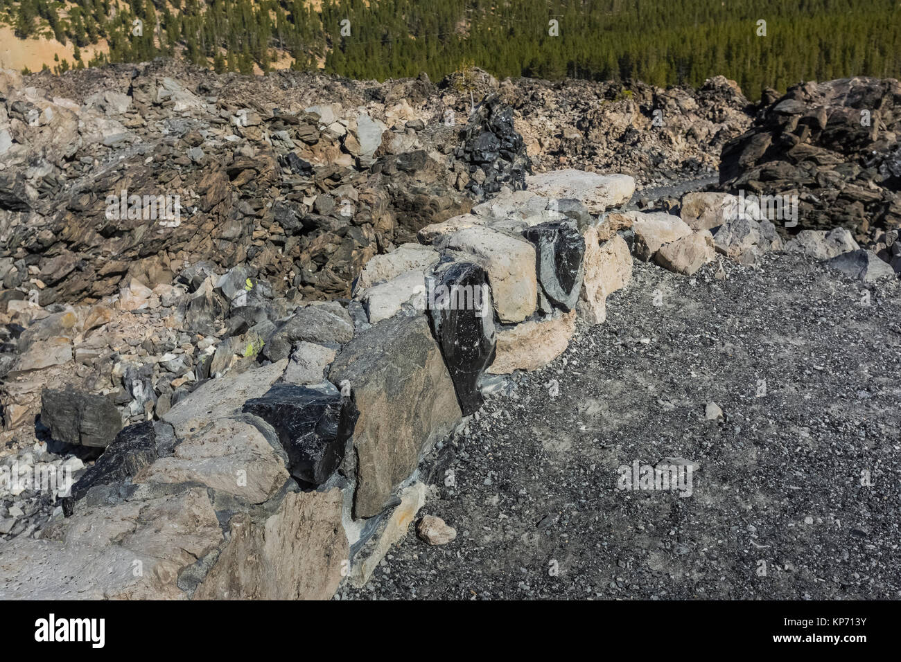 Rock wall at interpretive platform along the Big Obsidian Flow Trail in Newberry National ...