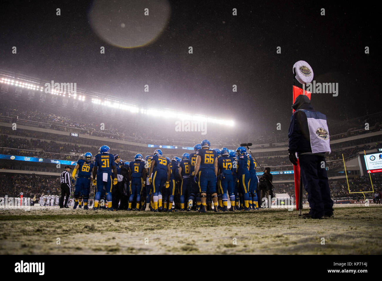 The U.S. Naval Academy football team huddles during a timeout at ...