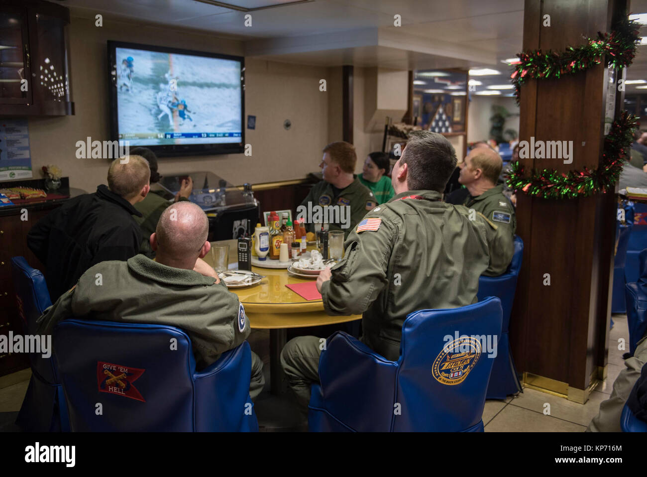 Sailors watch the annual Army-Navy college football game in a ward room ...