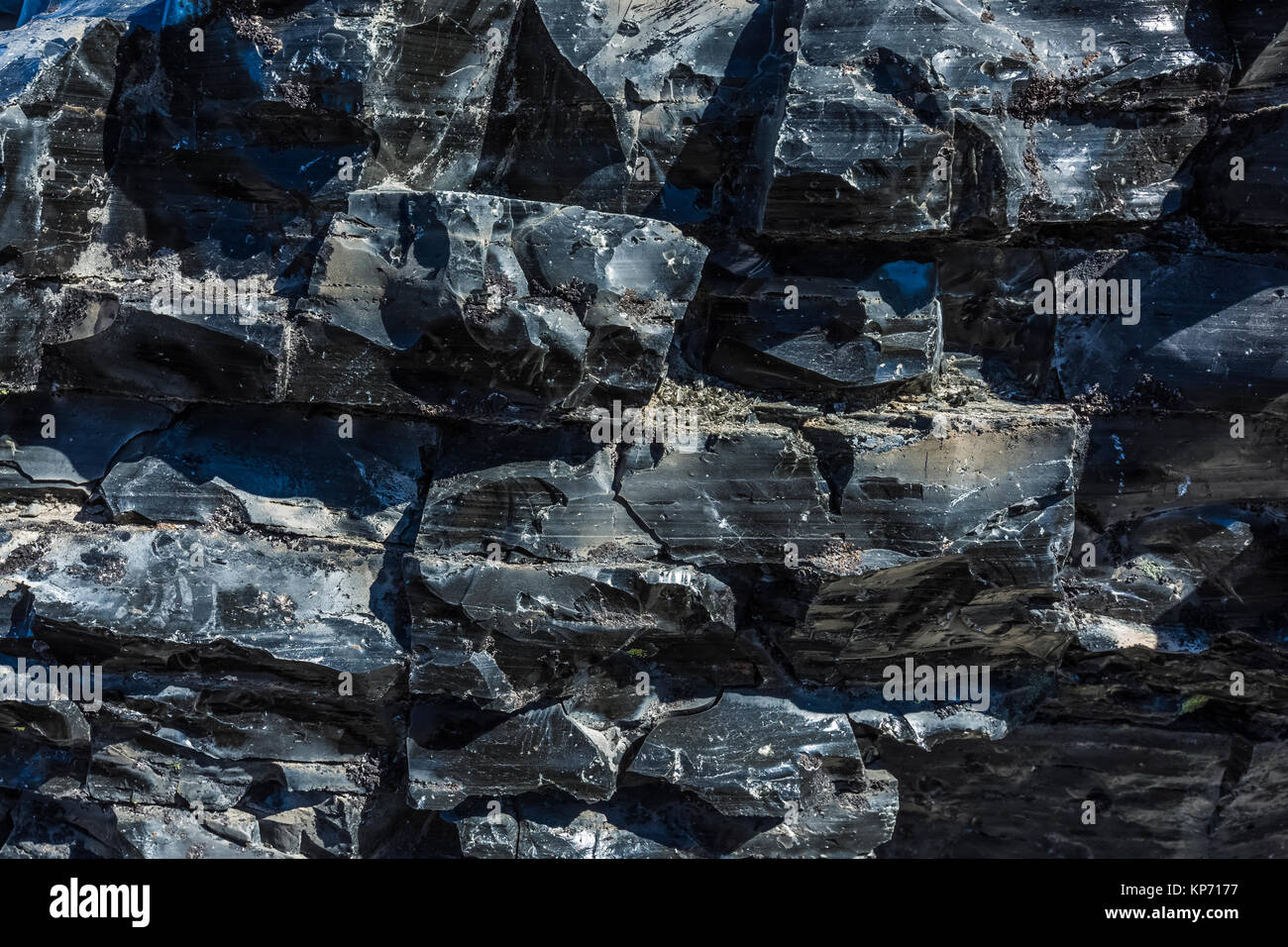 Close-up of obsidian, with its combination of dark color and glassy ...