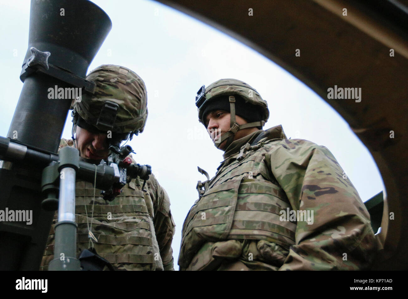 Spc. Michael Erskine (left), and Pvt. Elijah Hayward (center), both ...