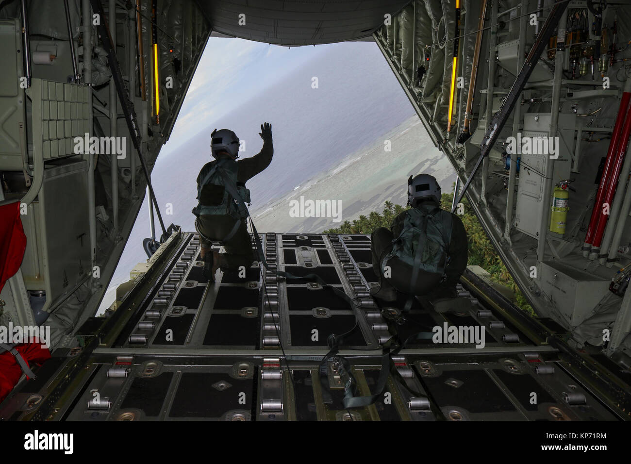 Airman 1st Class Stephen Clark, 36th Airlift Squadron loadmaster, waves to people on a ...
