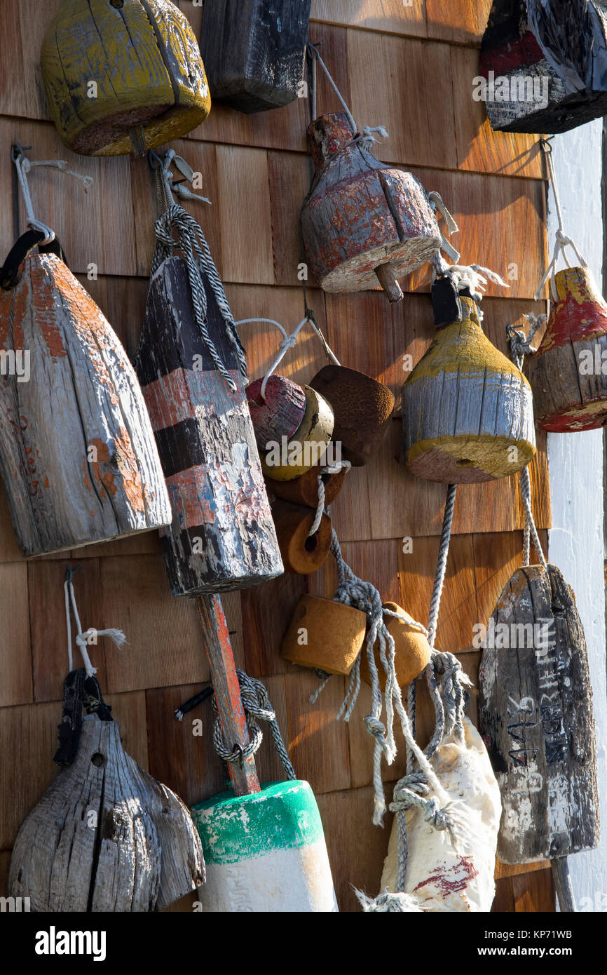 Wooden buoys on rustic fence on sunny day in coastal Portsmouth, NH ...