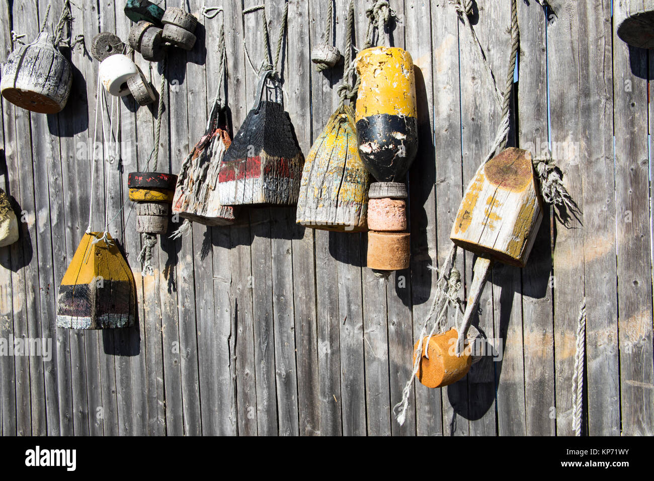 Wooden buoys on rustic fence on sunny day in coastal Portsmouth, NH ...