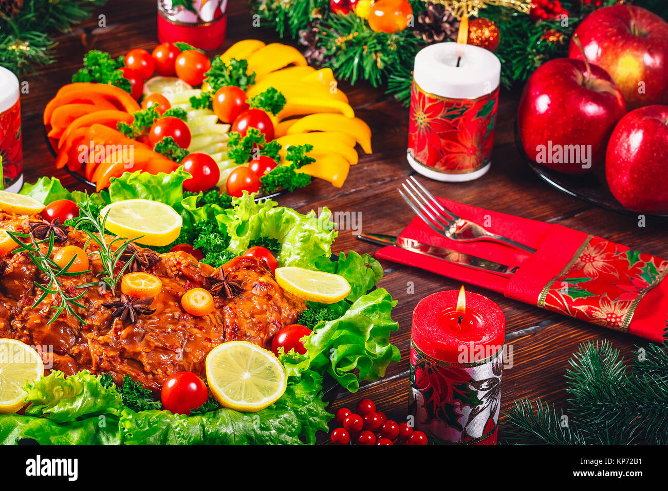 Christmas table dinner time with roasted meats, candles and New Year ...