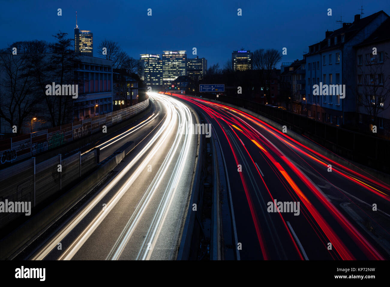 Light trails on Autobahn A40 motorway with the Essen skyline at the ...