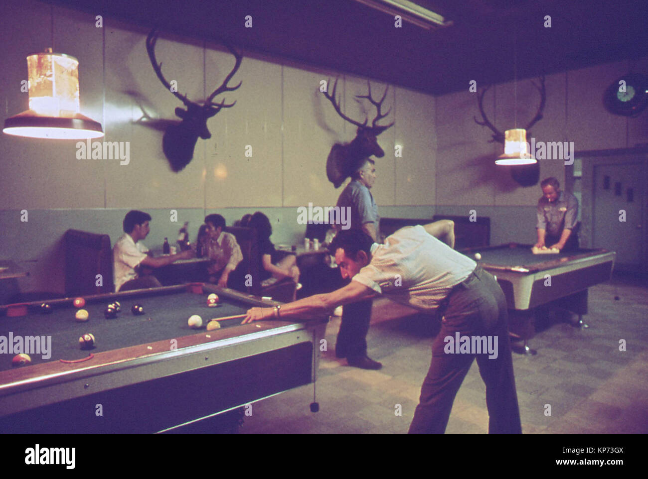 early 1970s pool hall men playing pool and drinking beer Stock Photo ...