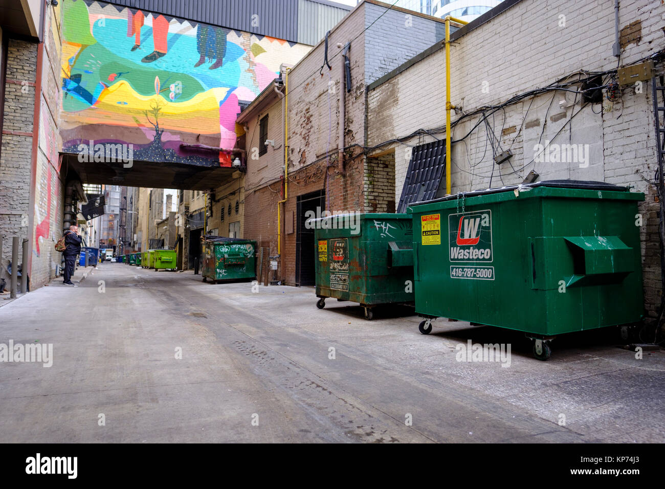 O'Keefe Lane alleyway with many green garbage dumpsters lined up ...