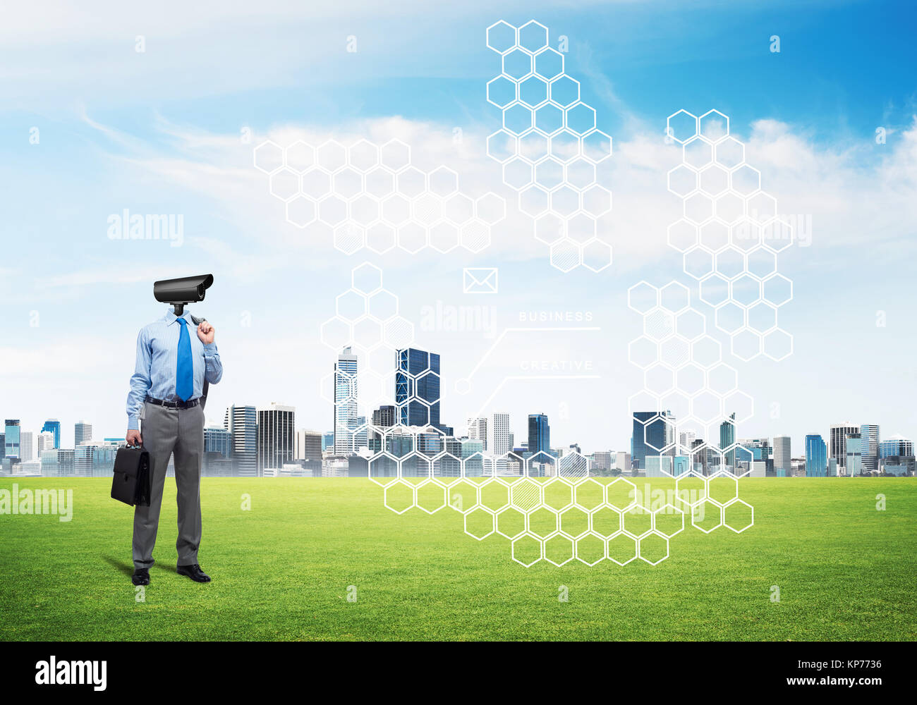 Camera headed man standing on green grass against modern cityscape ...