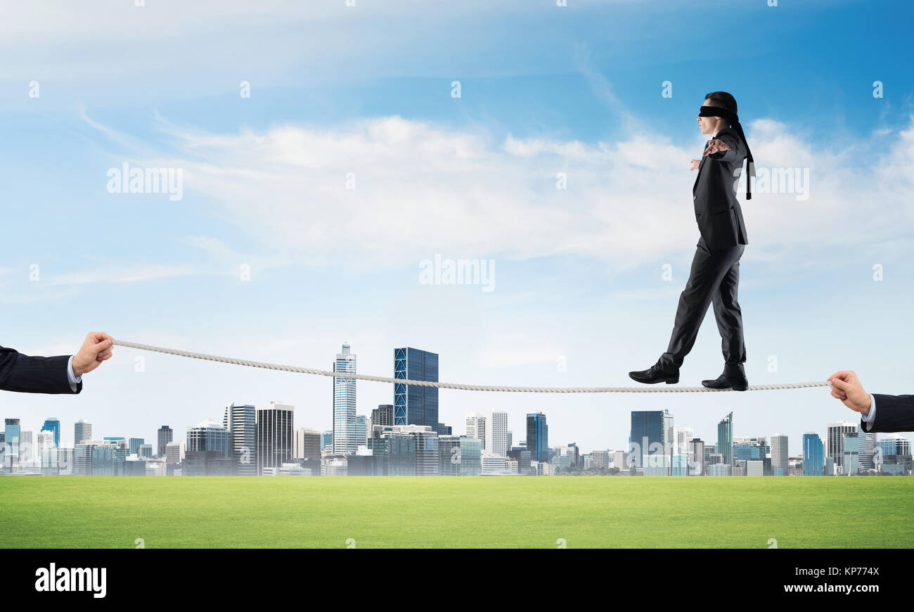 Business concept of risk support and assistance with man balancing on ...