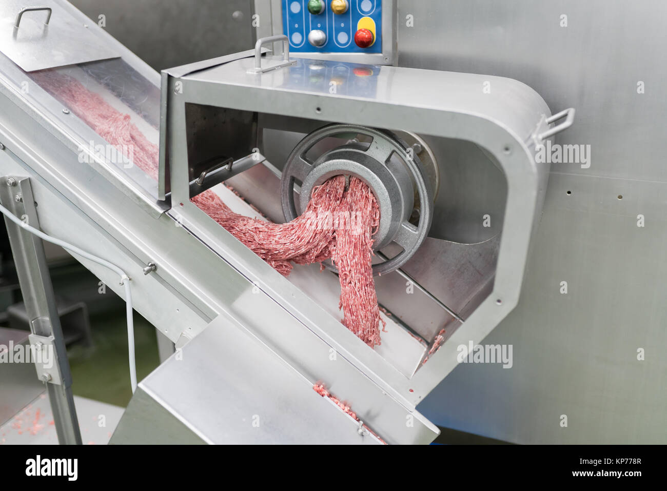 Ground beef and pork being ground in a factory Stock Photo - Alamy
