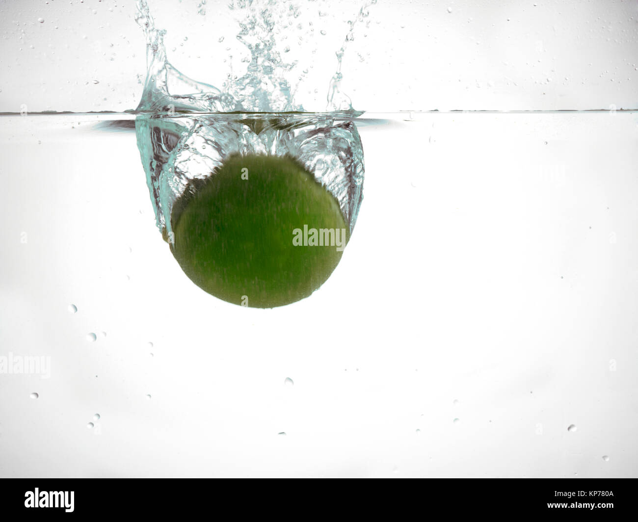 fresh lime falling into water Stock Photo - Alamy